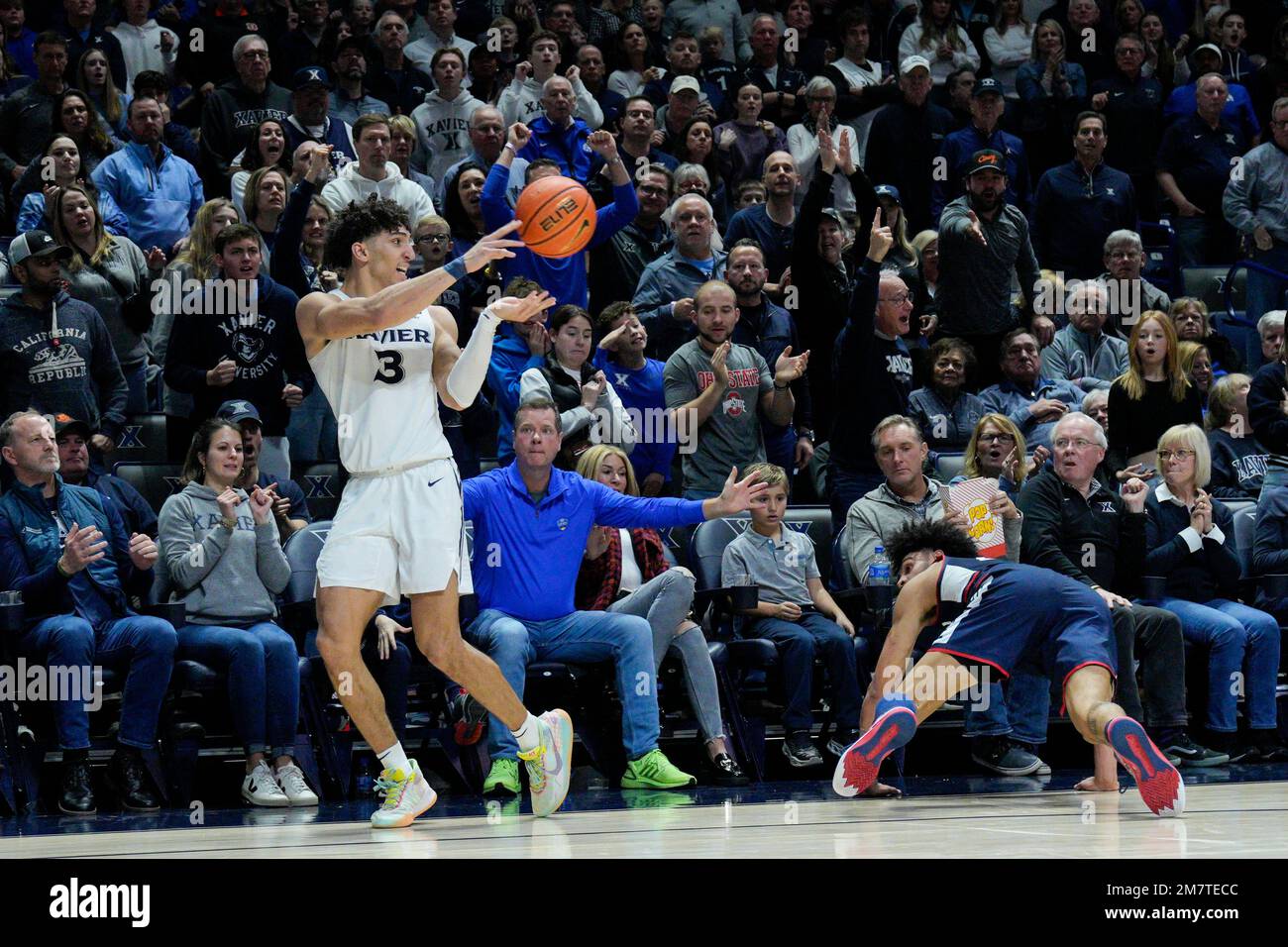 Xavier Musketeers guard Colby Jones (3) fights to keep a ball in bounds ...