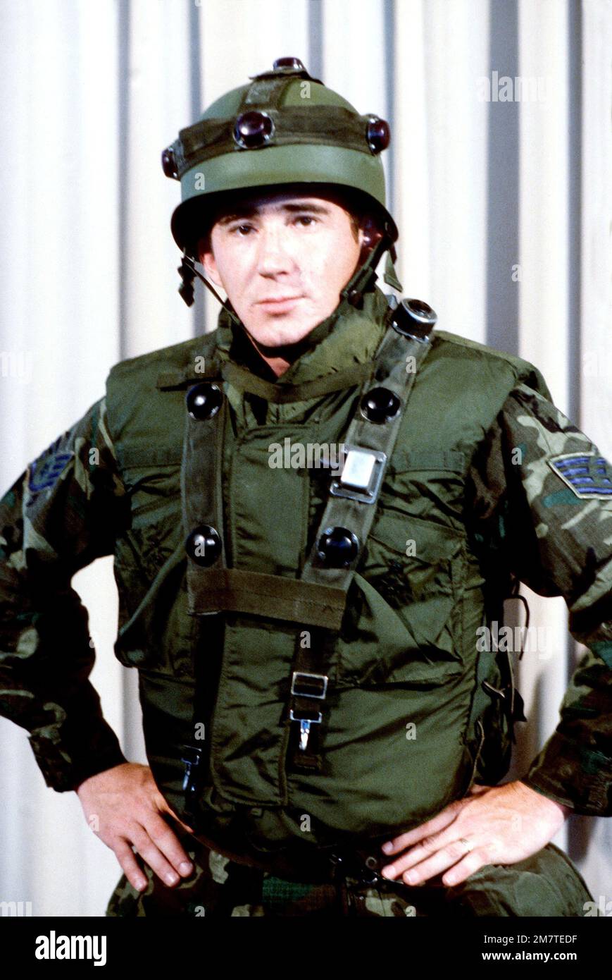 A security policeman wears a vest and helmet, equipped with part of the ...