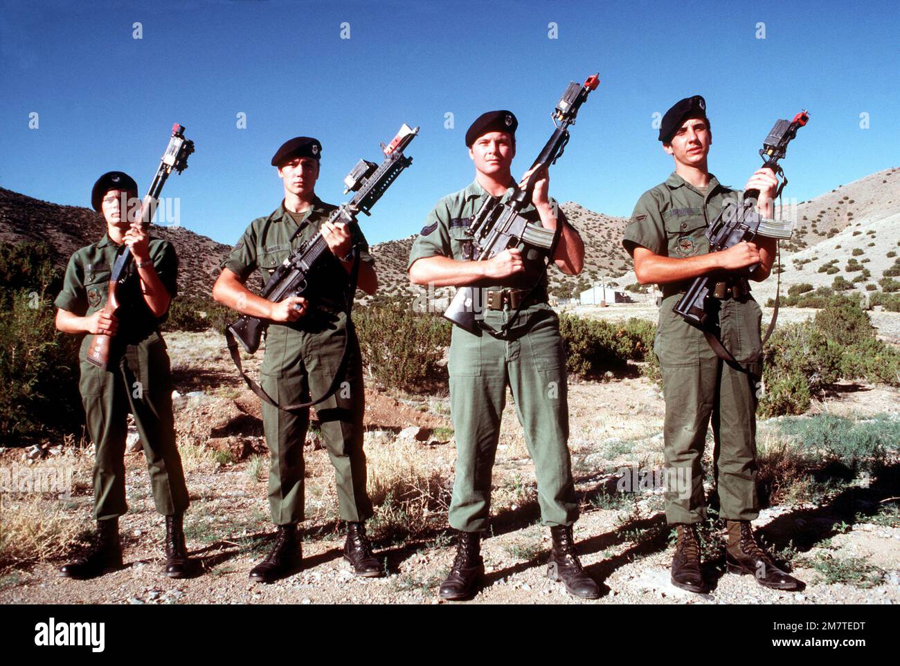 Security policemen pose with rifles, equipped with part of the Multiple ...