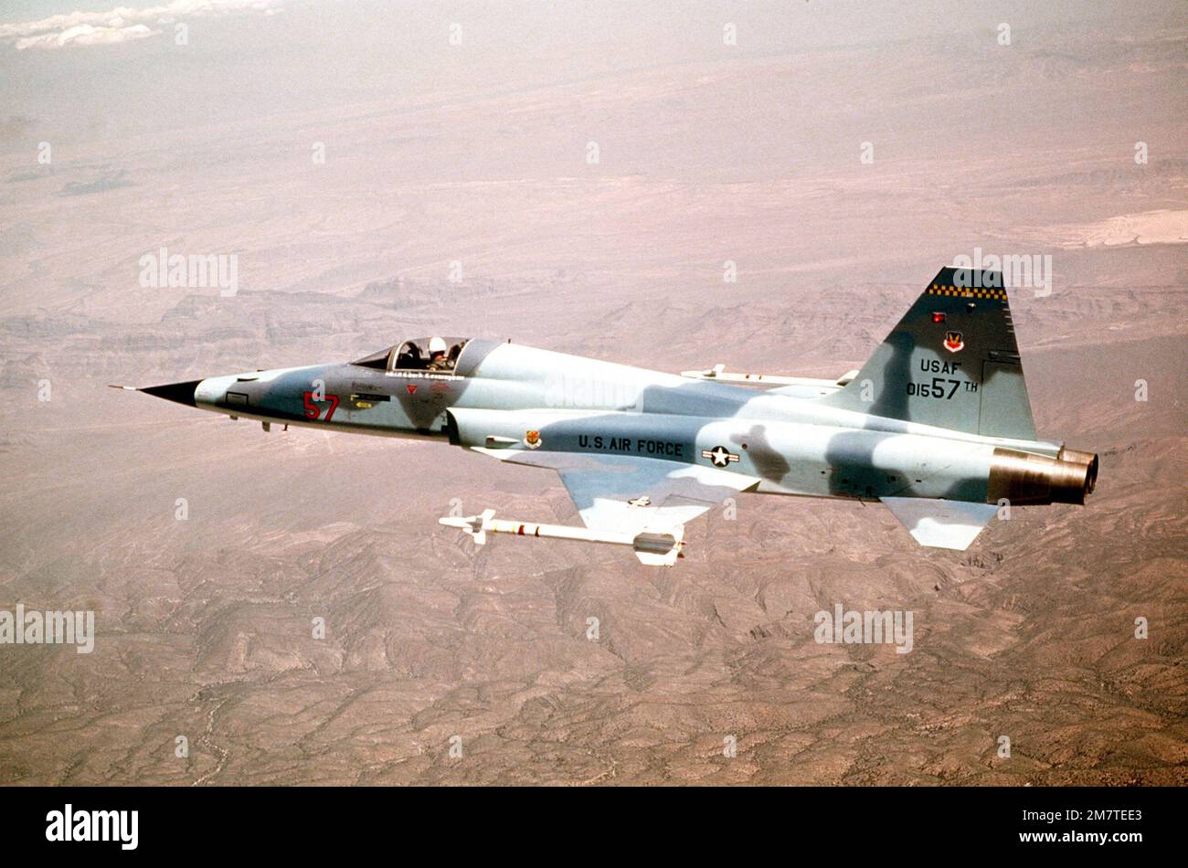 An air-to-air left side view of an F-5 Tiger II aircraft carrying AIM-9 ...