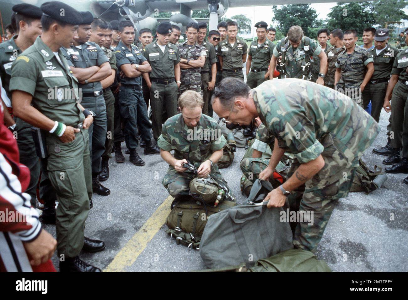 Combat control team (CCT) members demonstrate the use of parachute gear ...