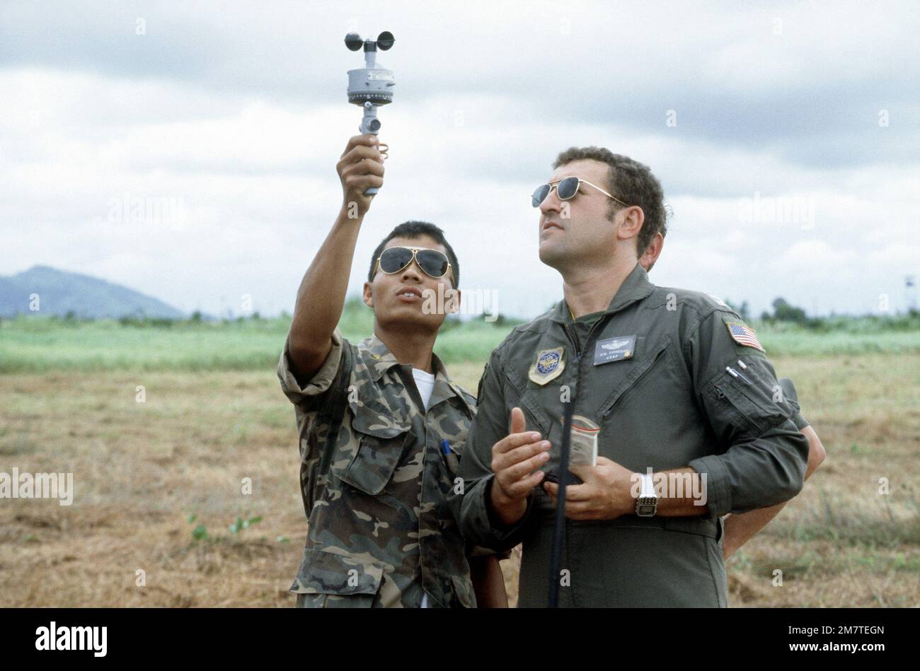 Combat control team (CCT) members and a Thai soldier use equipment to ...