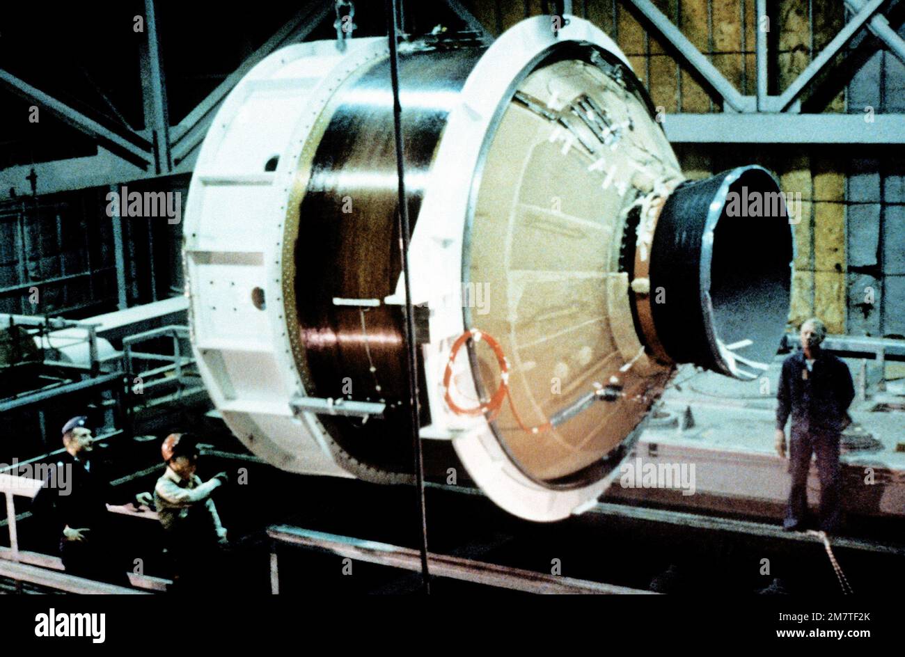 An Air Force officer visits the Inertial Upper Stage module, under ...
