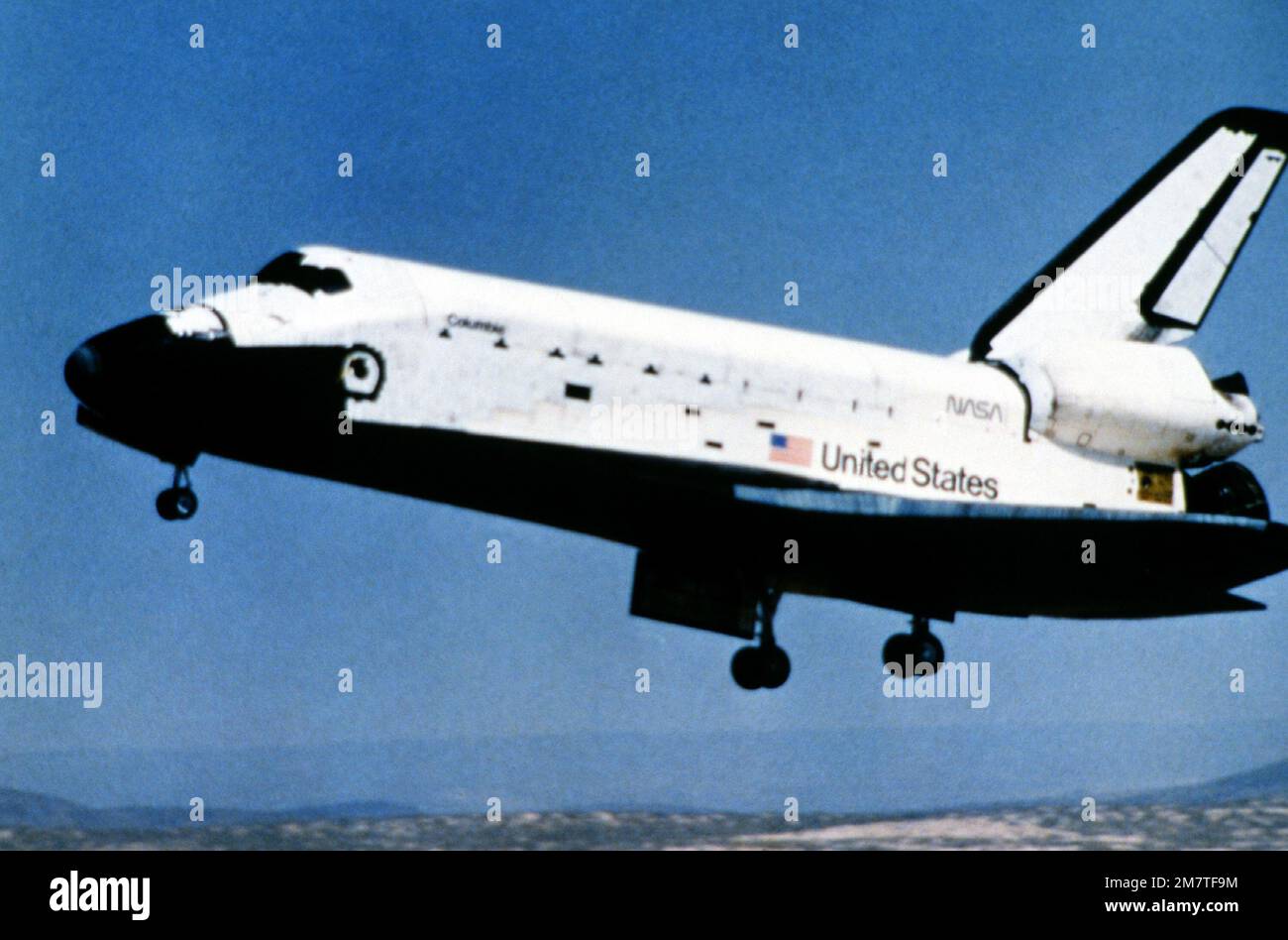 A left front view of the Columbia space shuttle orbiter landing. Base: Edwards Air Force Base ...