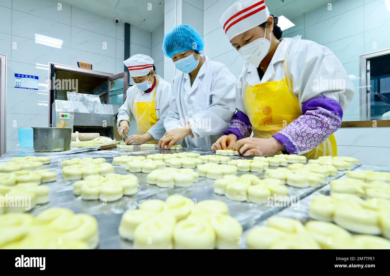 ZHANGYE, CHINA - JANUARY 10, 2023 - A worker makes "sugar huagzi" at the bun making workshop of ...