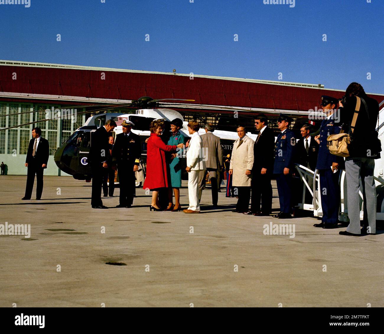 President and Mrs. Ronald Reagan are greeted by RADM Fred Baughman and ...