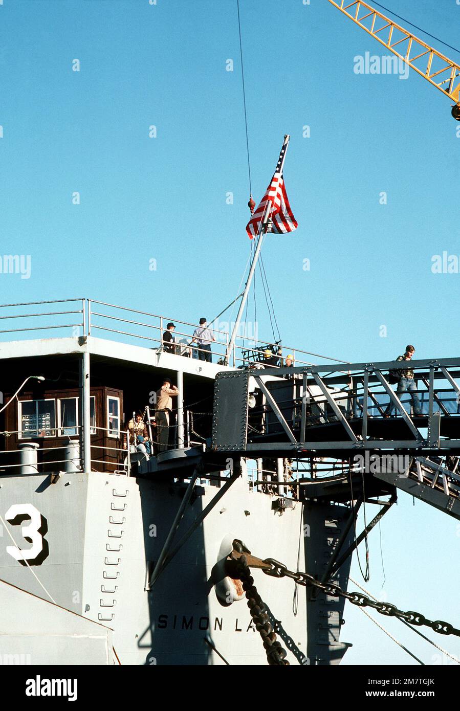 A crewman uses the gangplank at the ship's stern to go ashore from the ...