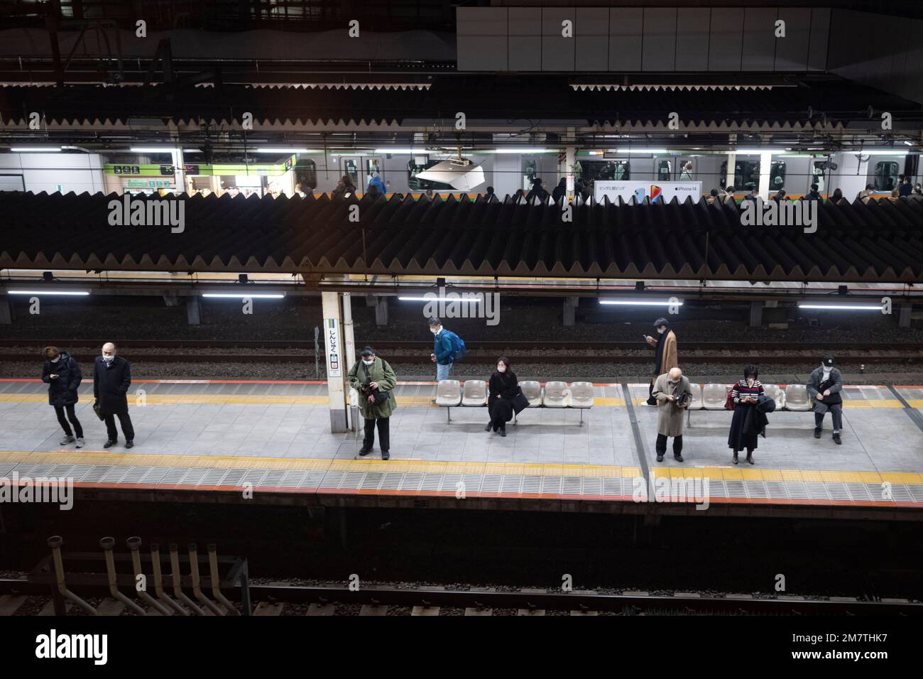 Tokyo, Japan. 6th Jan, 2023. Commuters wait on a platform at Shinjuku ...