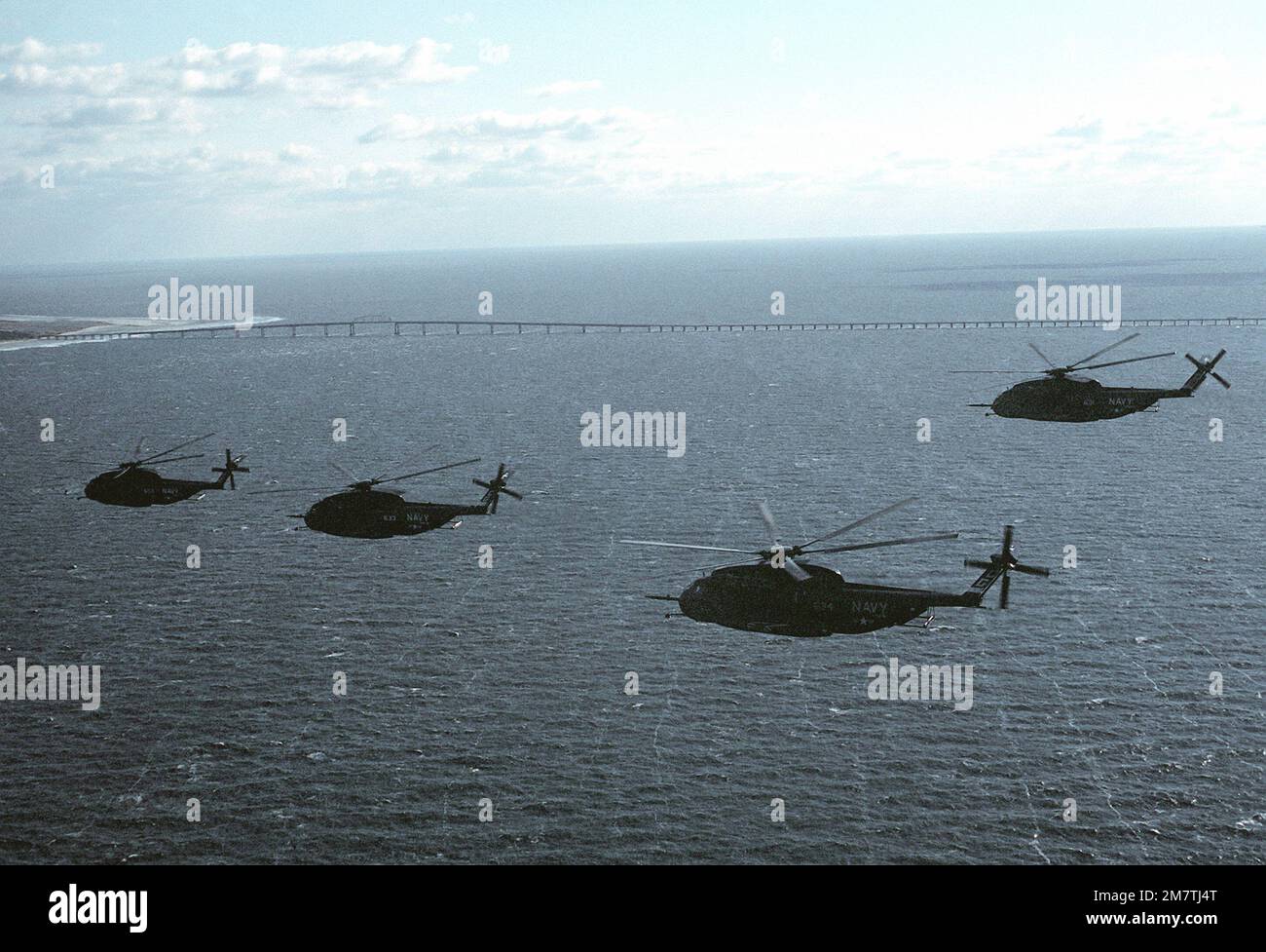Left side view of four RH-53D Sea Stallion helicopters in flight near ...
