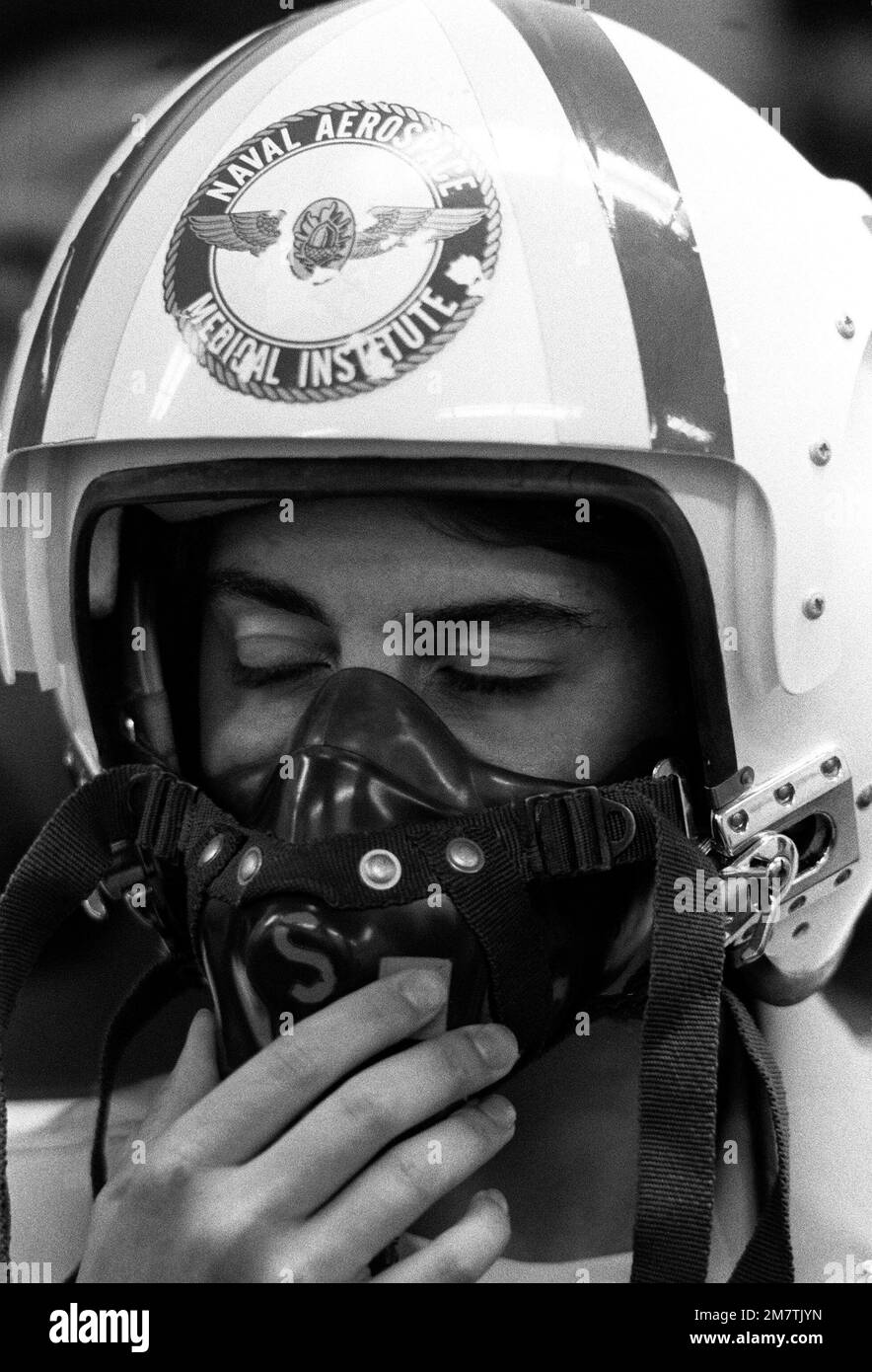 A candidate checks the fit on her oxygen mask before a pressure chamber ...