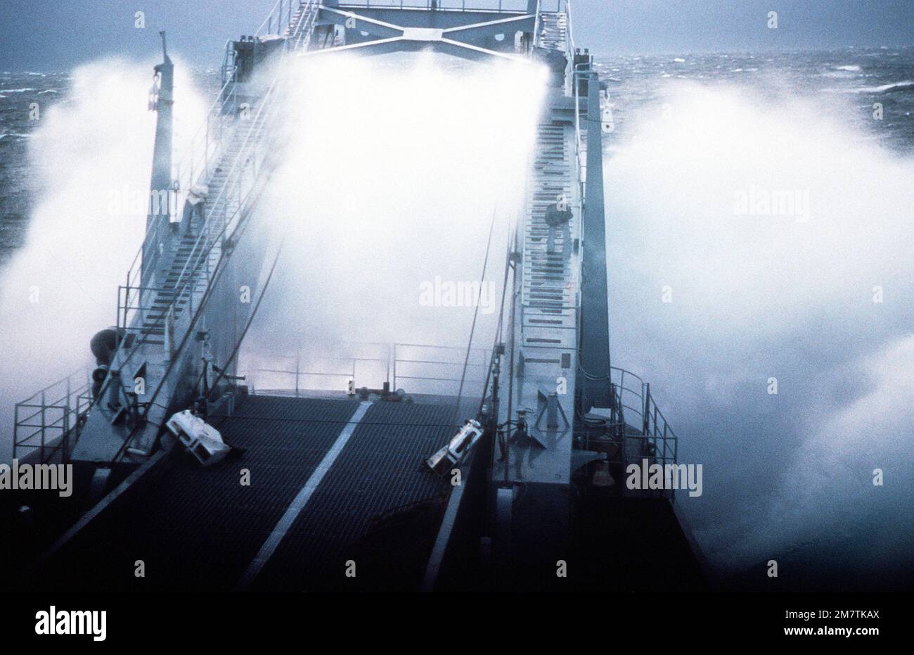 A wave breaks over the bow of the tank landing ship USS RACINE (LST ...