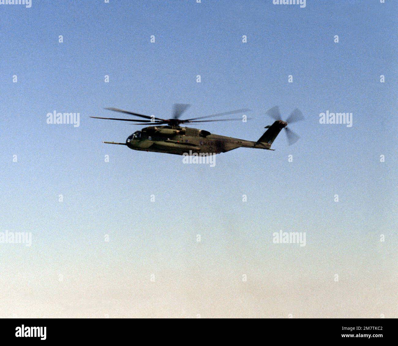 An air-to-air left side view of a CH-53E Super Stallion helicopter ...