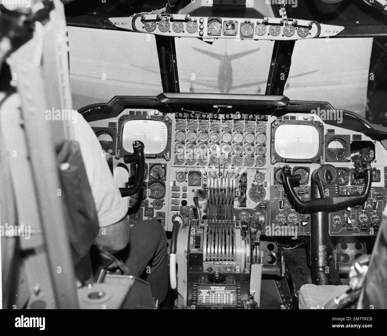 A pilot seated in a B-52 Weapon System Trainer prepares to practice ...