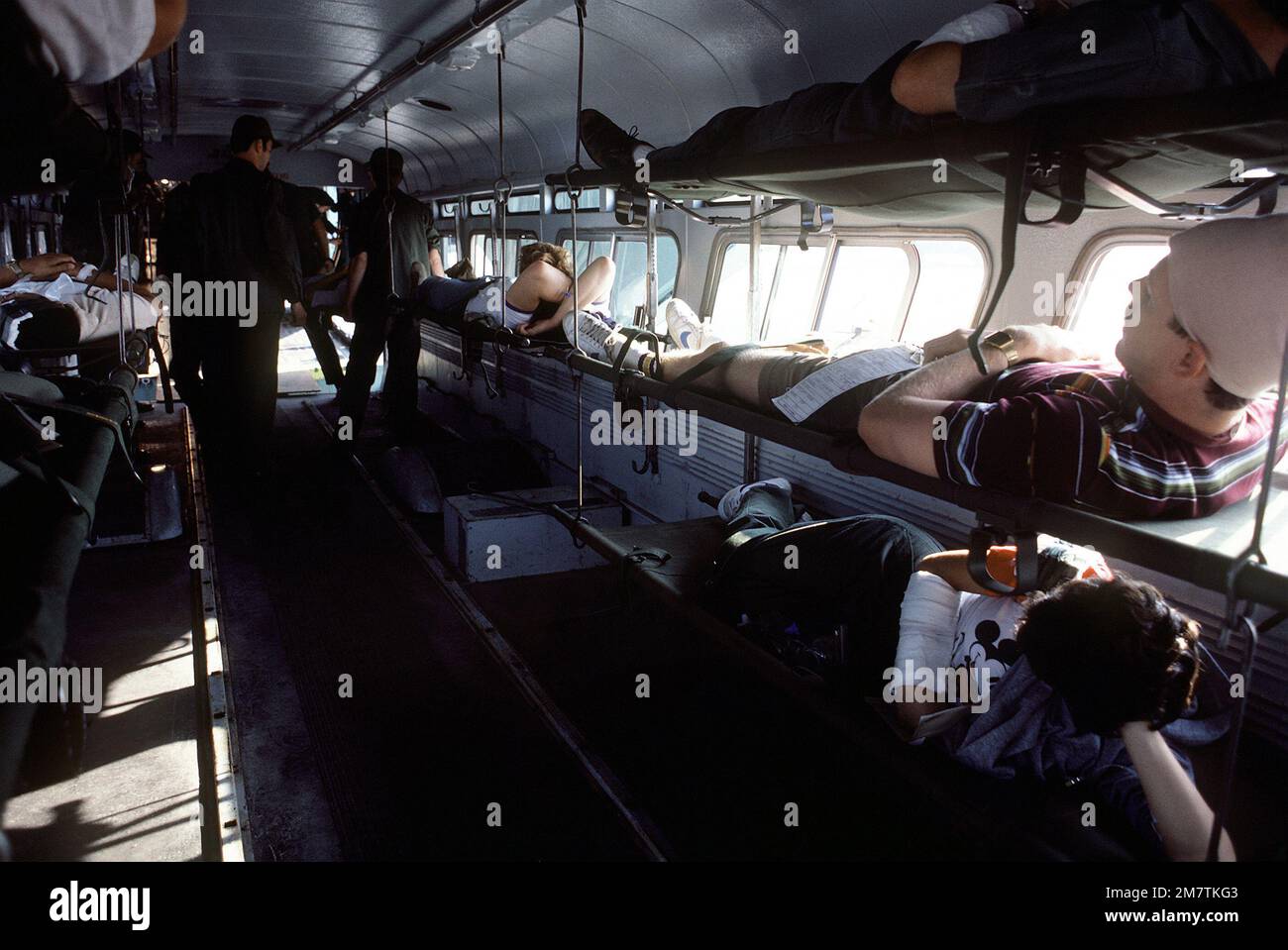 Casualties" waiting in a medical bus are being transferred to a C-141B ...