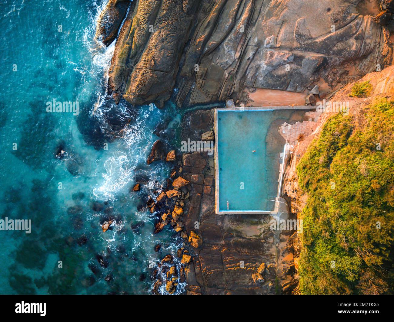 Aerial views of the early morning golden light shining on the rocks and ...