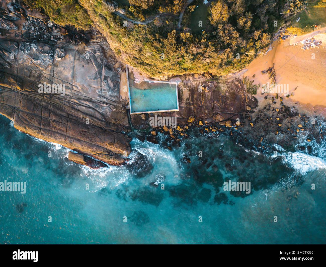 Beach rock pool tidal pool built against the cliff in the rocks at the ...