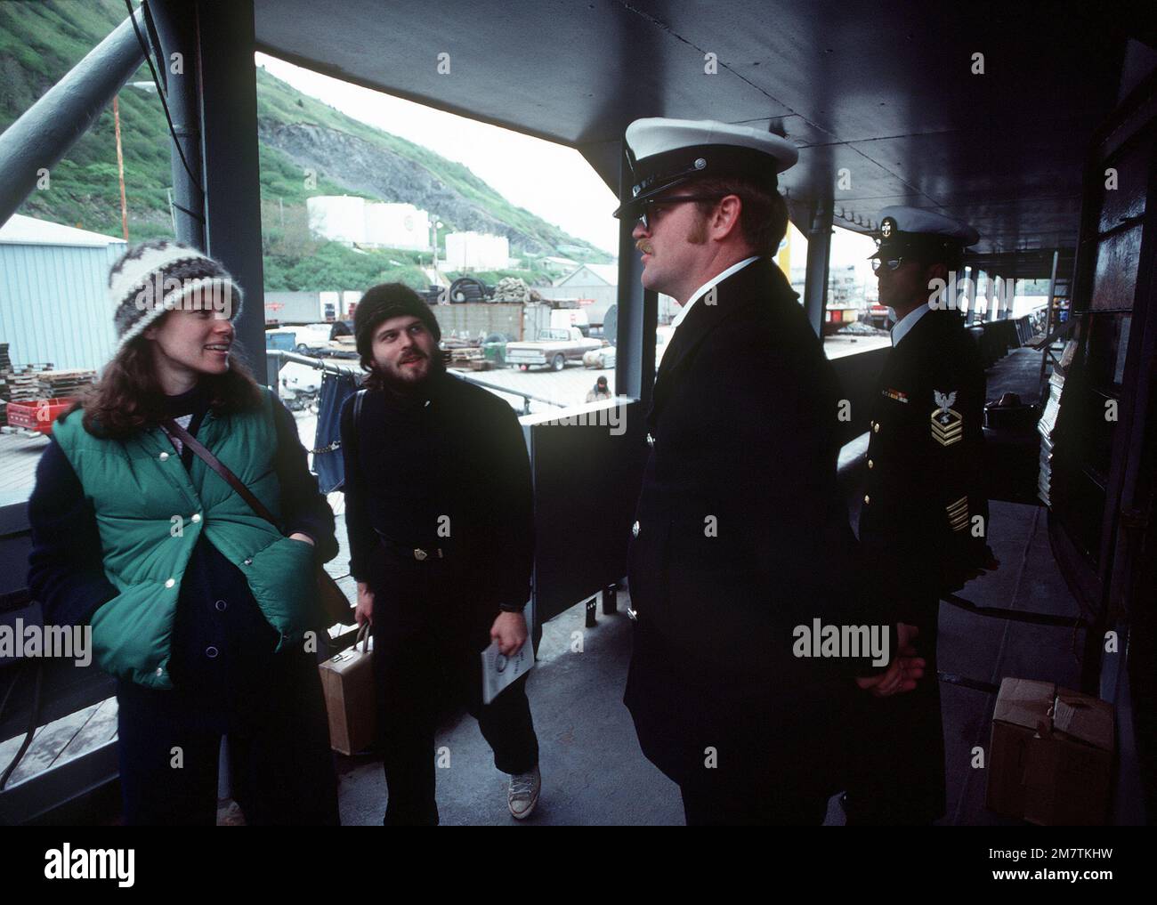 Visitors on aboard the ammunition ship USS PYRO (AE-24) talk with ...
