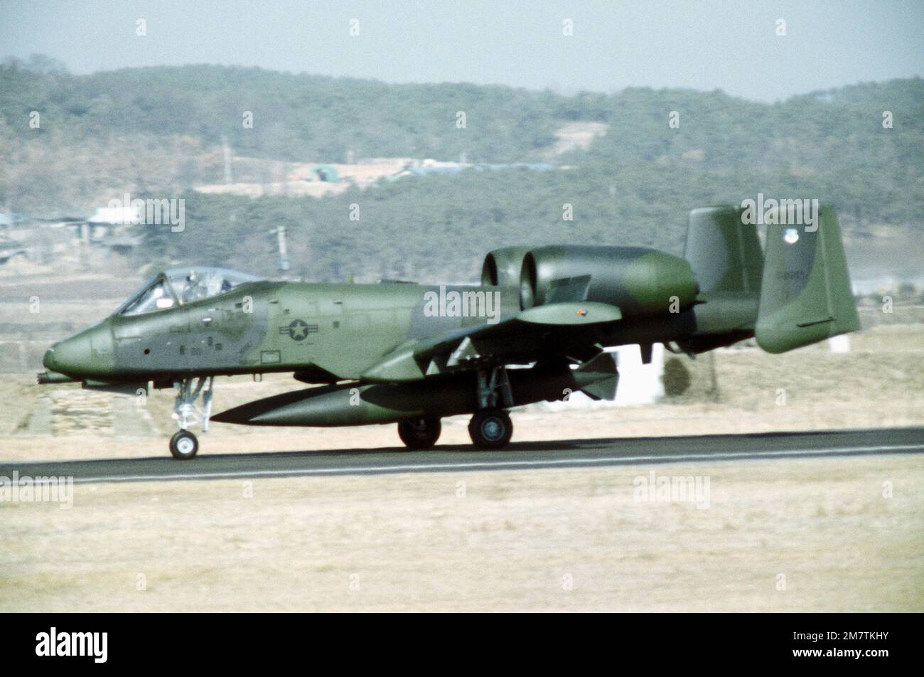 A left side view of an A-10 Thunderbolt II aircraft landing during ...