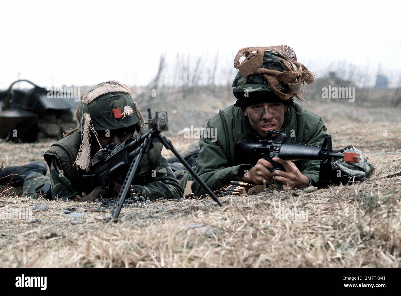 U.S. Marines operate M-60 machine guns, left, and an M-16 rifle, right ...