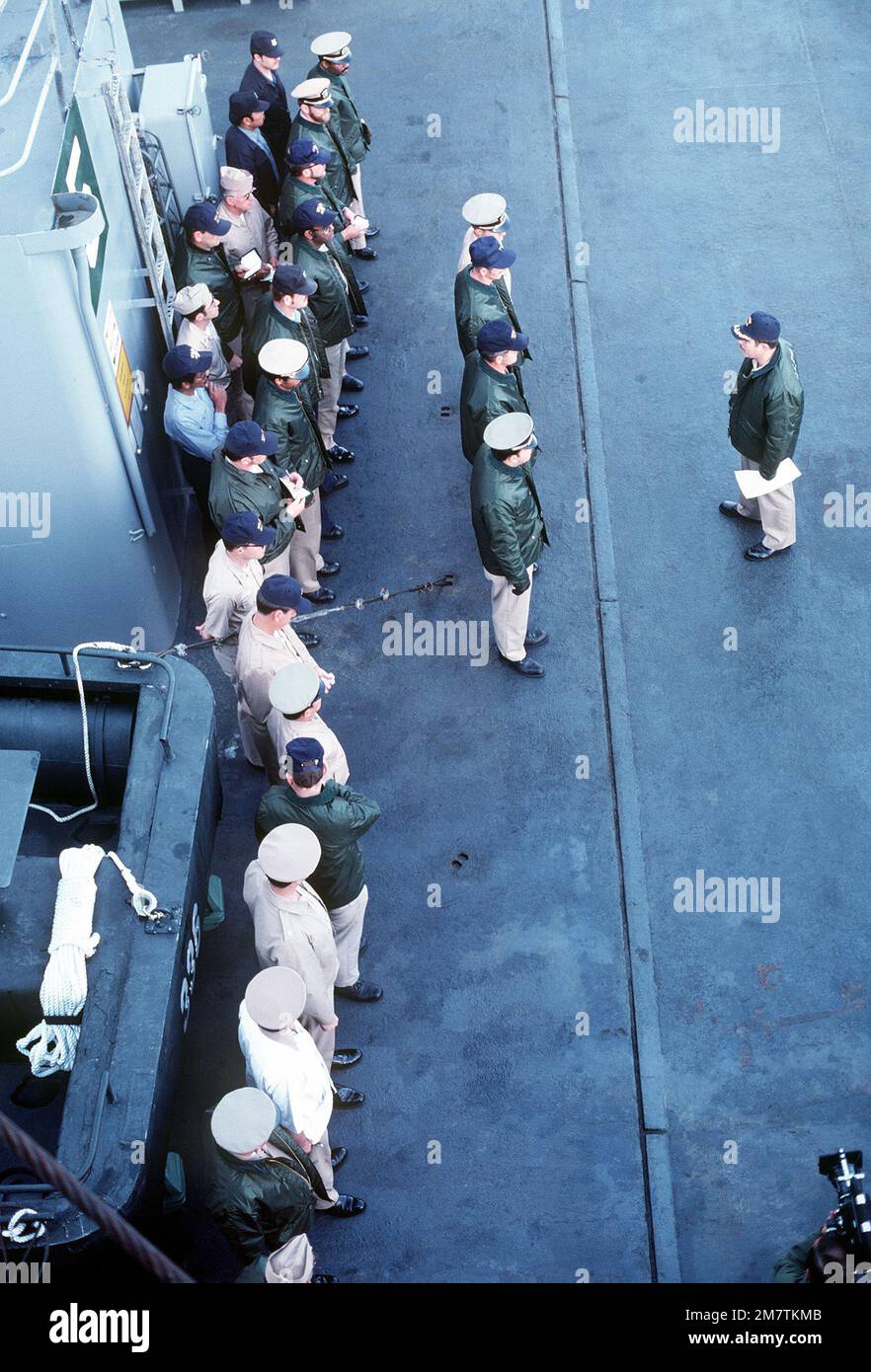 Officers on aboard the ammunition ship USS PYRO (AE-24) are briefed on ...