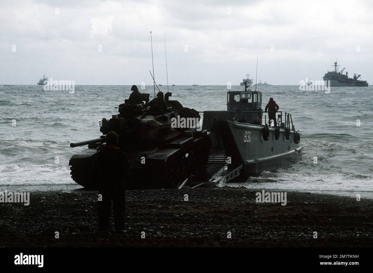 A combat tank, aboard a mechanized landing craft (LCM-8), lands during ...