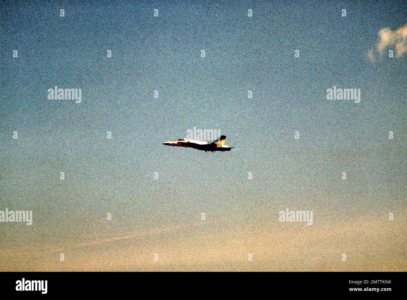 A left side view of an F-18 Hornet aircraft during flight ...