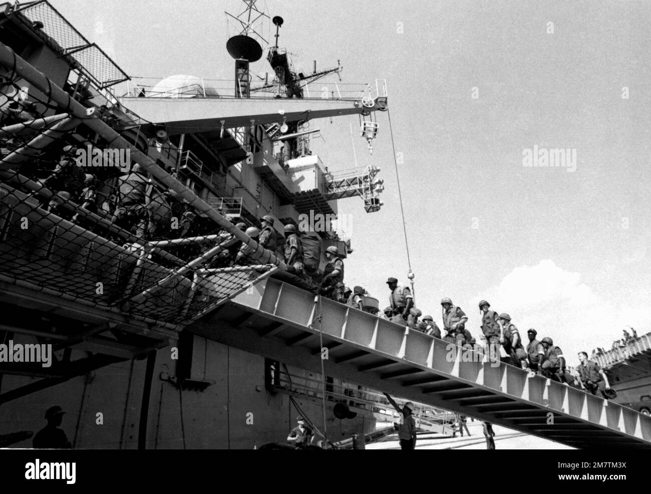 U.S. Marines board the amphibious assault ship USS TRIPOLI (LPH-10) for ...