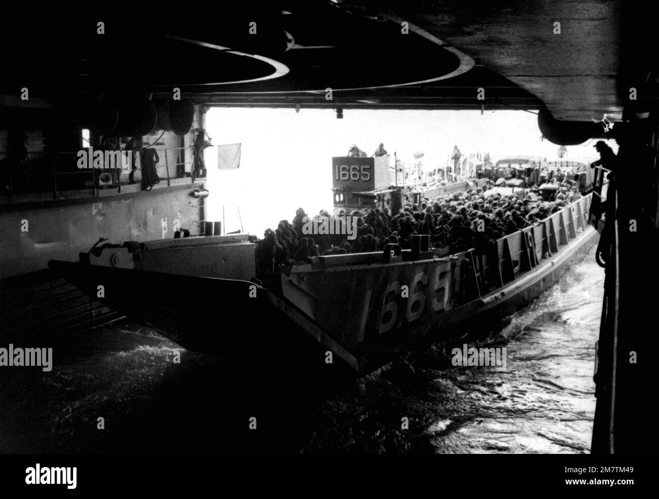 A utility landing craft (LCU-1665) departs the well-deck of the ...