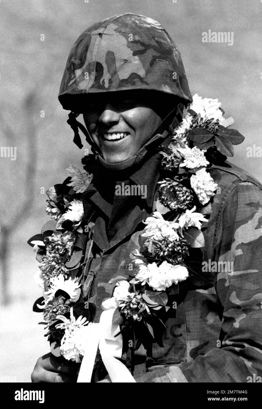 Marine Corps LCPL Stephen Dickerson, India Company, displays a flower ...