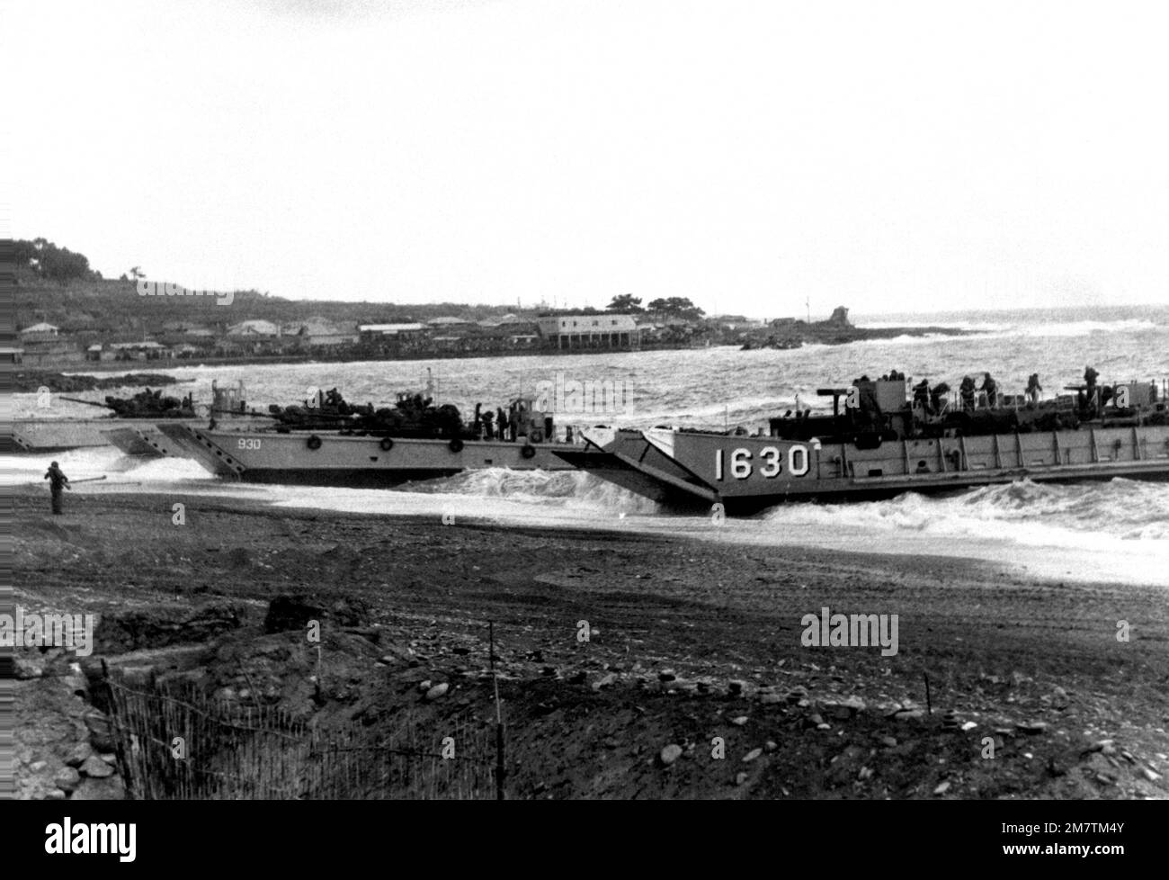 Navy and Marine Corps troops, aboard the utility landing craft, land ...