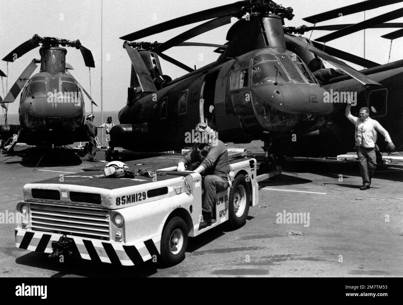 Sailors move and maintain CH-46 Sea Knight helicopters from Marine ...