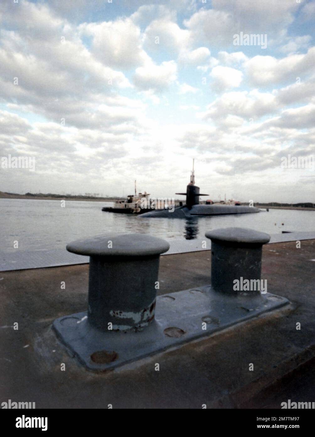 A tug assists the nuclear-powered strategic missile submarine USS OHIO ...