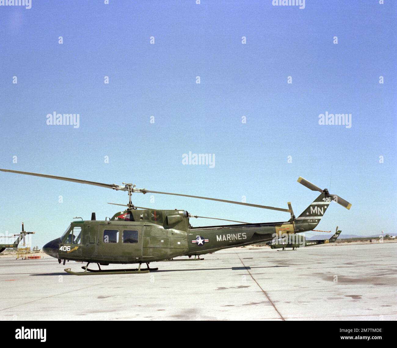A left side view of a Marine UH-1N Iroquois (Huey) helicopter sitting ...