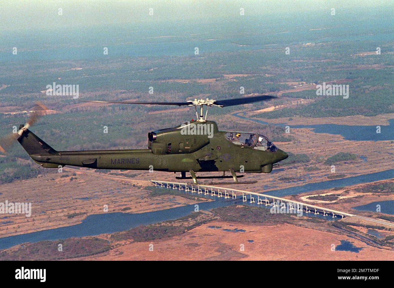 An air-to-air right side view of a Marine AH-1J Sea Cobra helicopter ...