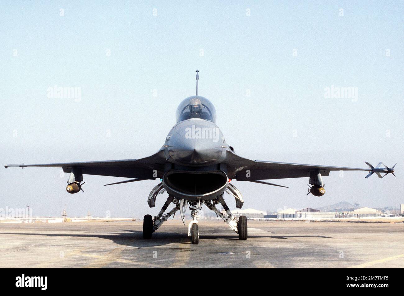 A front view of an F-16 Fighting Falcon aircraft armed with an AIM-9L ...