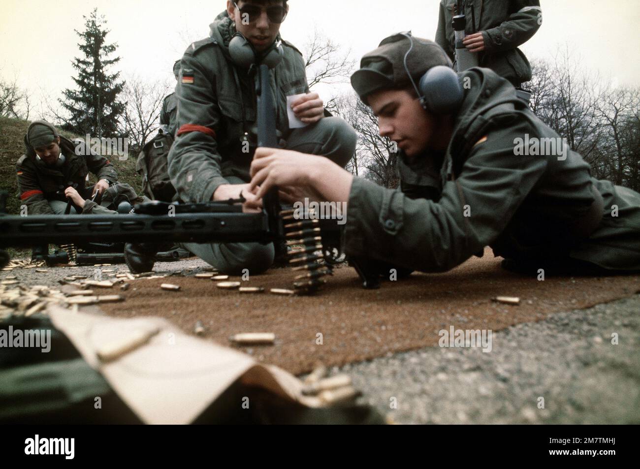 A German cadet assists a U.S. Air Force Academy cadet loading a German ...