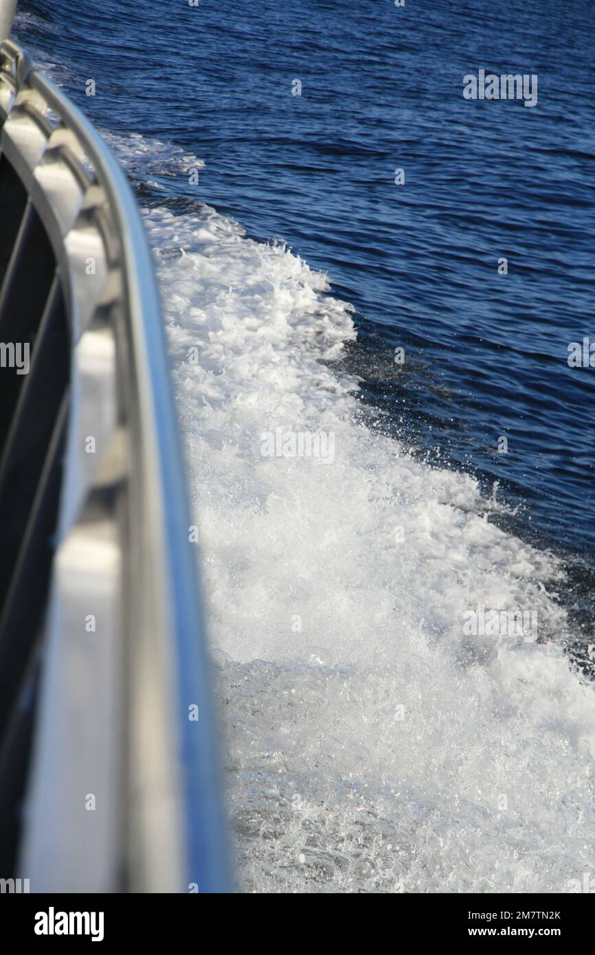 A vertical shot of splashing white water on the edge of a boat Stock ...