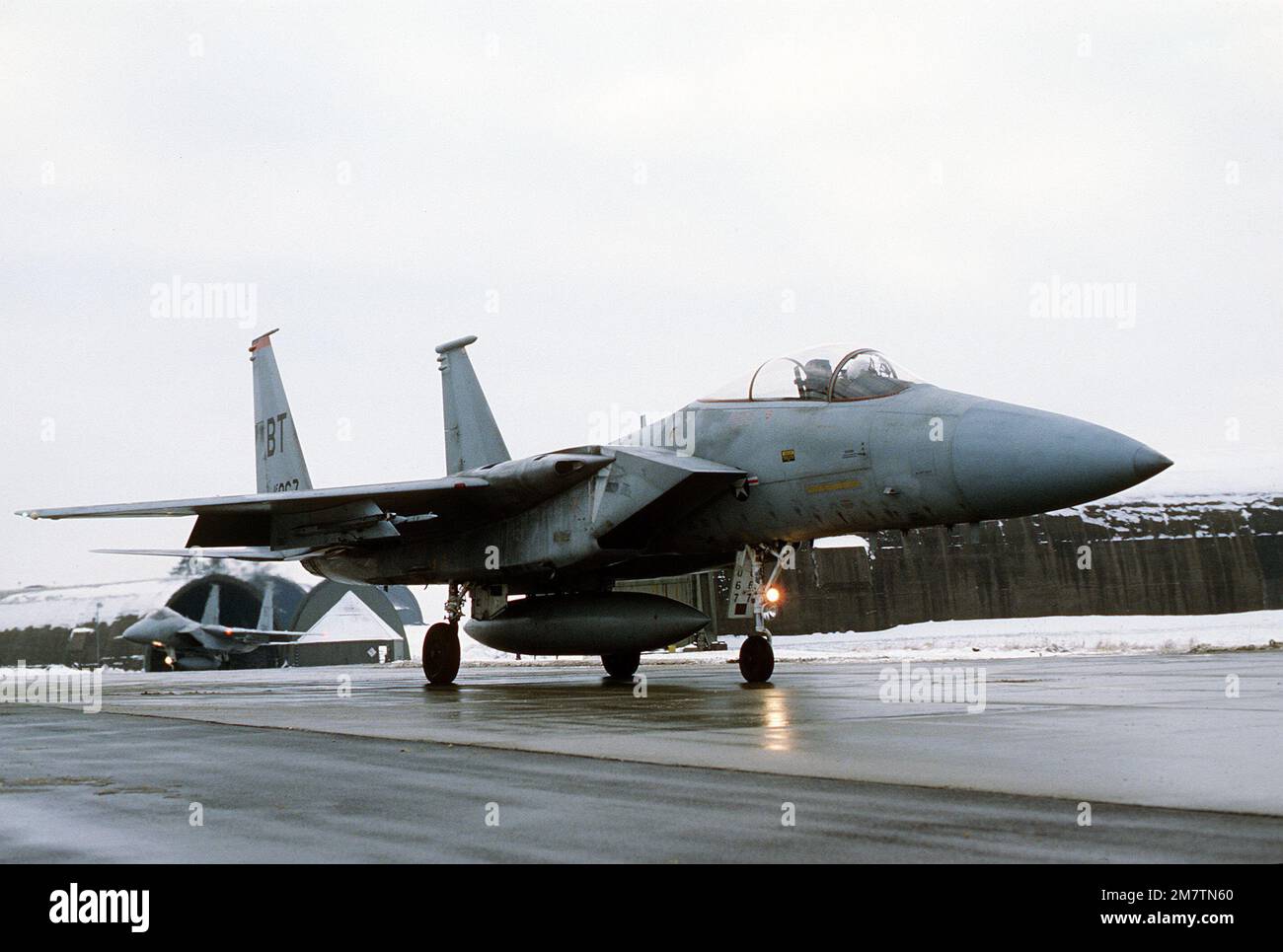 A right front view of an F-15 Eagle aircraft taxiing on the flight line ...