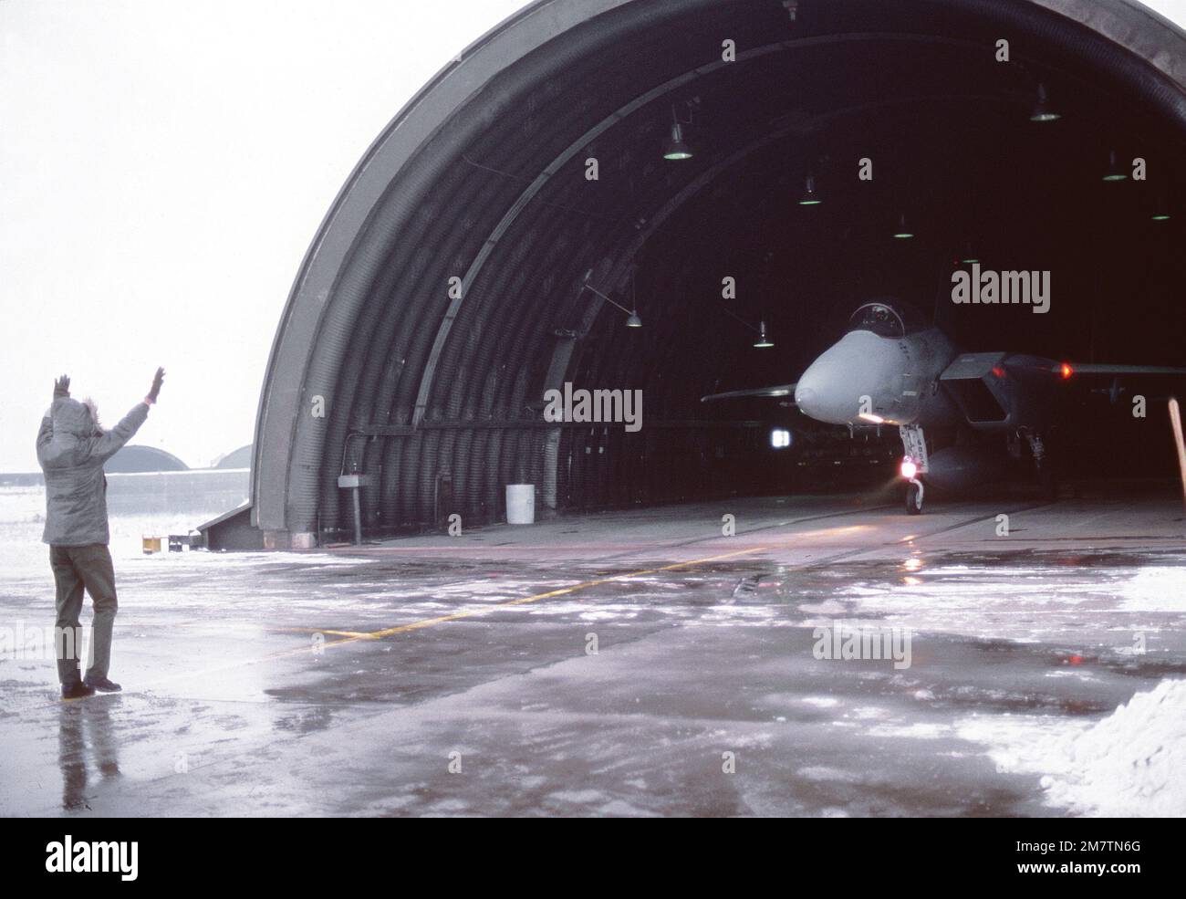 A left front view of an F-15 Eagle aircraft in a tabvee shelter ready ...