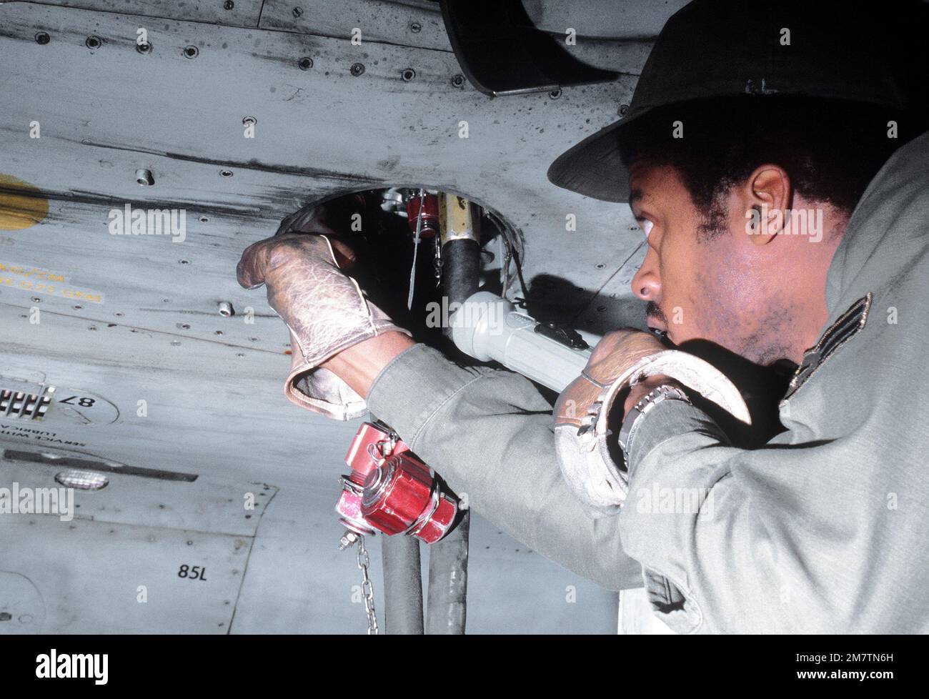 AN airman checks an F-15 Eagle aircraft wheel access panel before ...