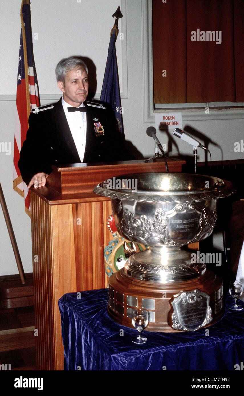 An Air Force colonel speaks before a crowd during an award ceremony ...