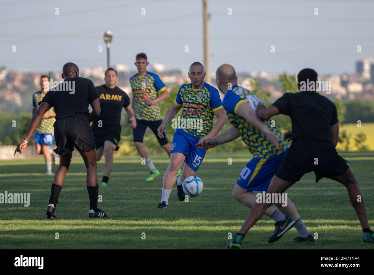 A Bulgarian player dribbles the ball down the field through defenders ...