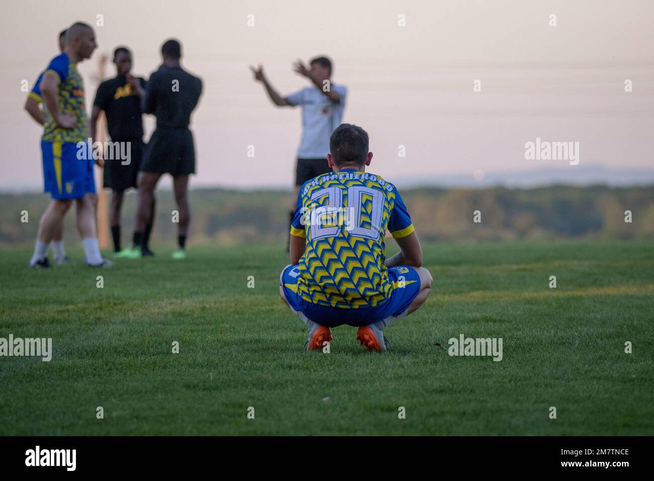 A Bulgarian player takes a rest while the referee makes a ruling during ...