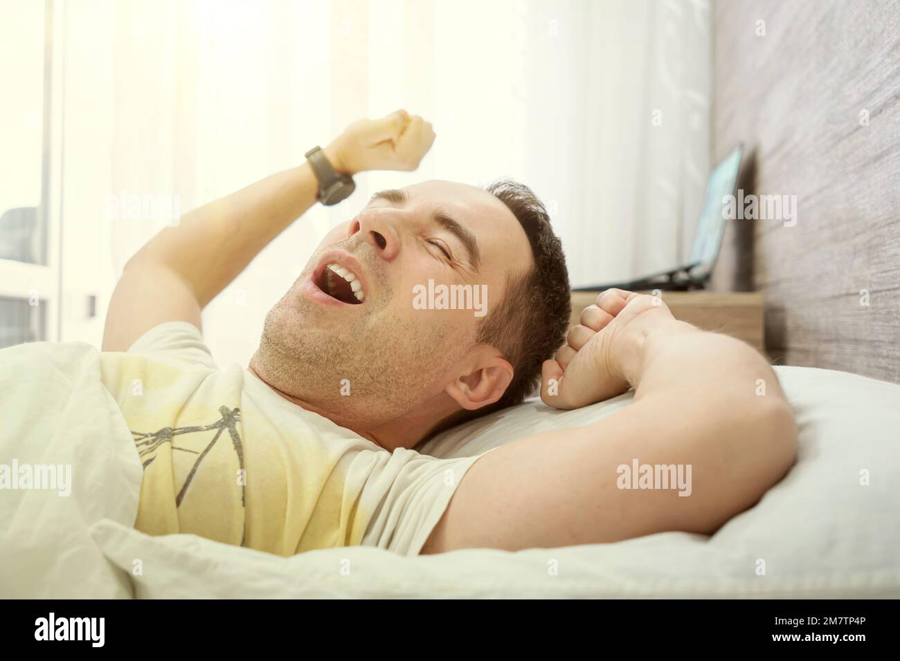 Handsome man waking up stretching hi-res stock photography and images ...