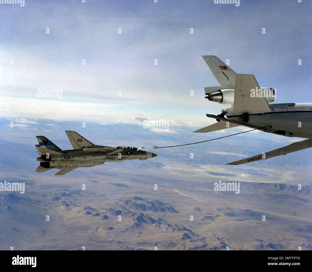 Air-to-air right side view of an F-14 Tomcat aircraft as it moves into ...