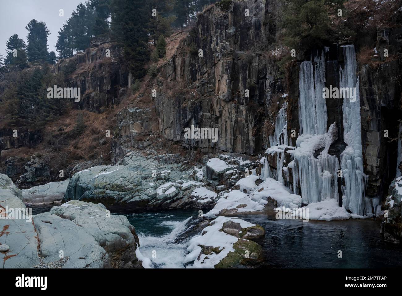 A view of frozen waterfall of Aharbal during a cold cloudy day in ...
