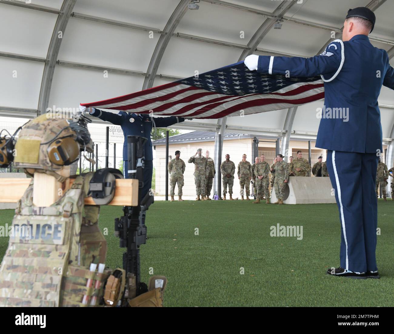 U.S. Airmen from the 325th Security Forces Squadron fold a flag during ...