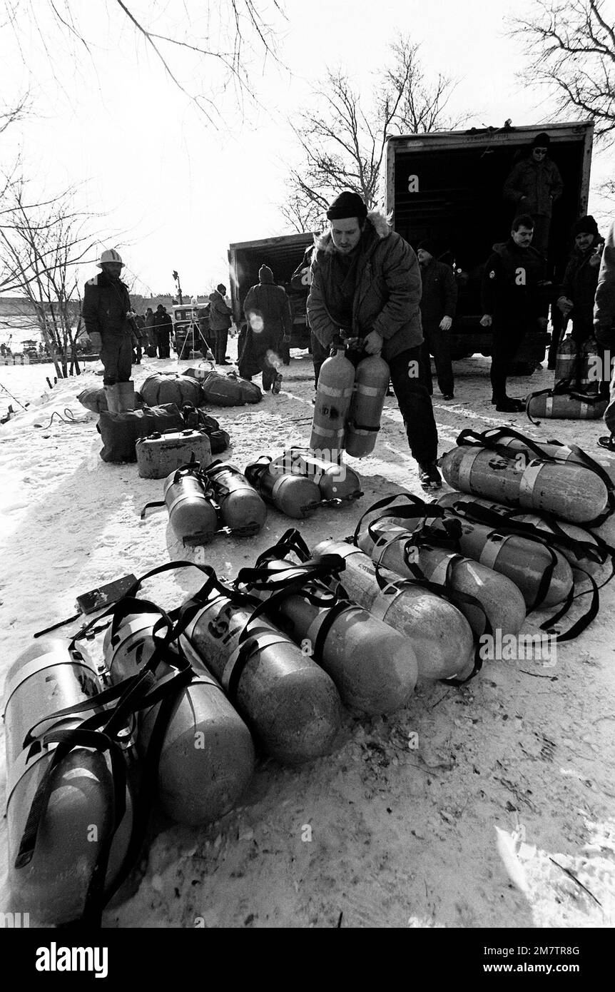GM1 Grant Williams lays out scuba tanks on the bank of the river in ...