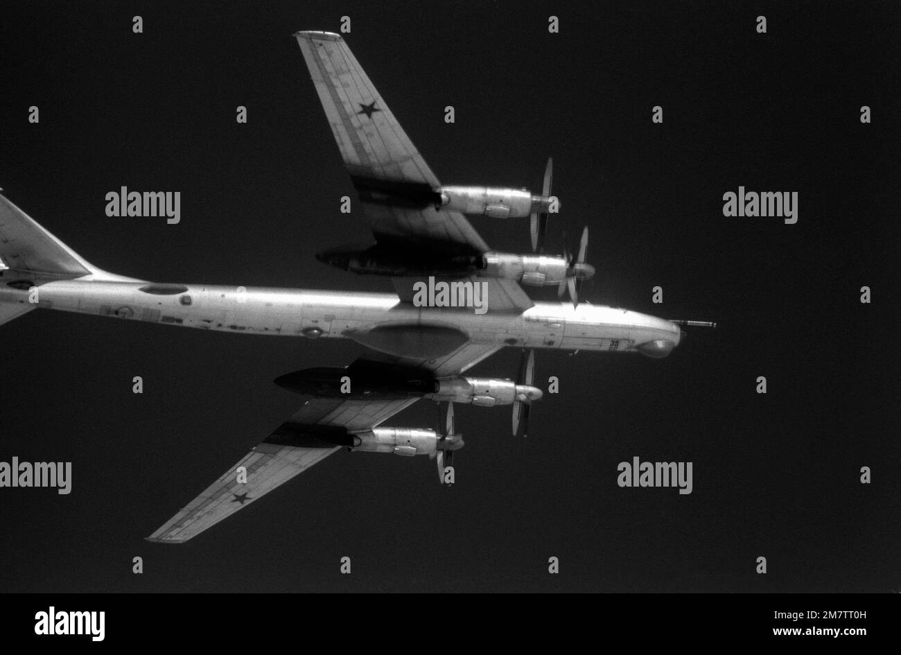 An air-to-air right underside view of a Soviet Tu-95 Bear aircraft ...