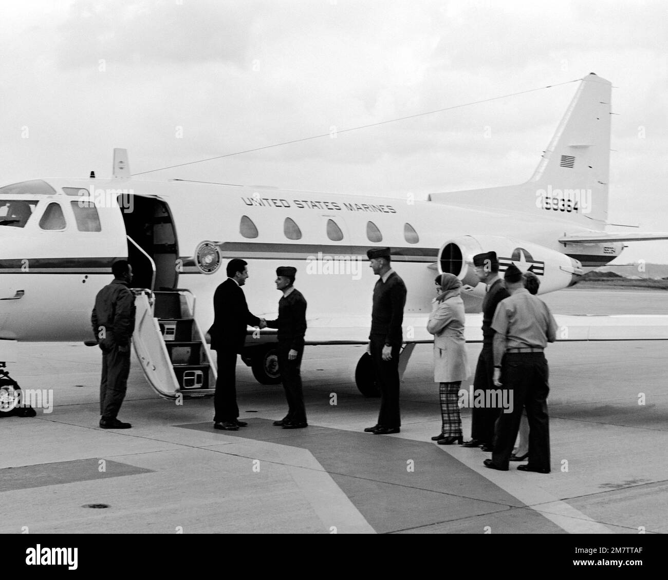 Secretary of the Navy John F. Lehman Jr., is greeted at Kadena Air ...